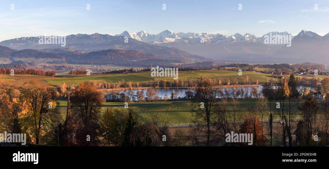 Panorama image of the Gerzensee Lake and villages with the Alps snow ...