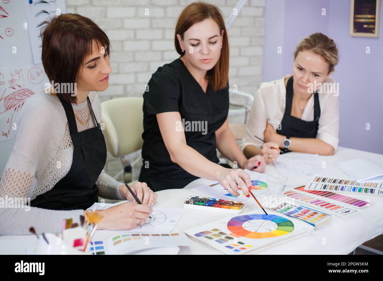 professional makeup courses ladies studying colors Stock Photo - Alamy