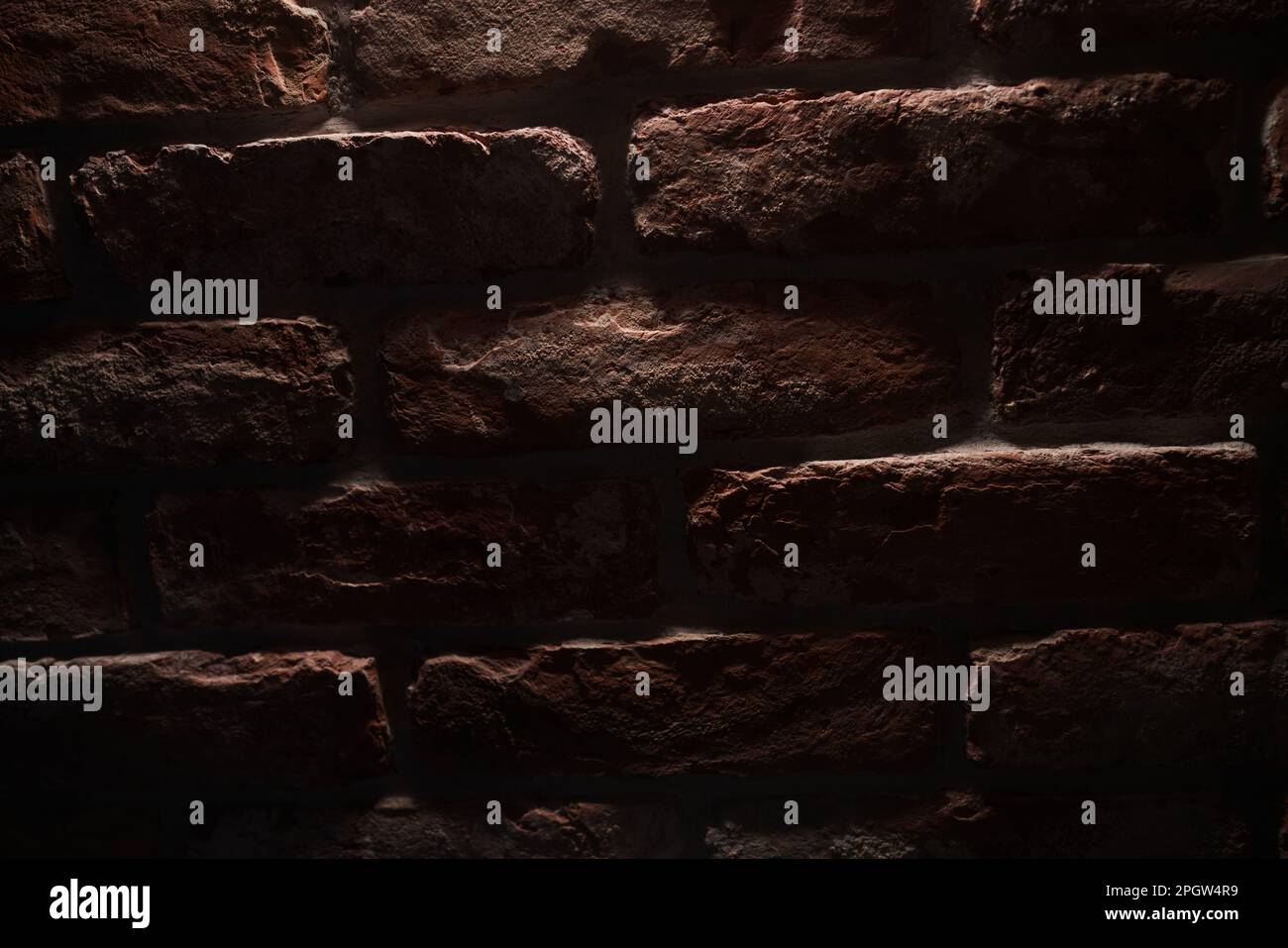 Old brisk wall with dramatic light, background Stock Photo - Alamy