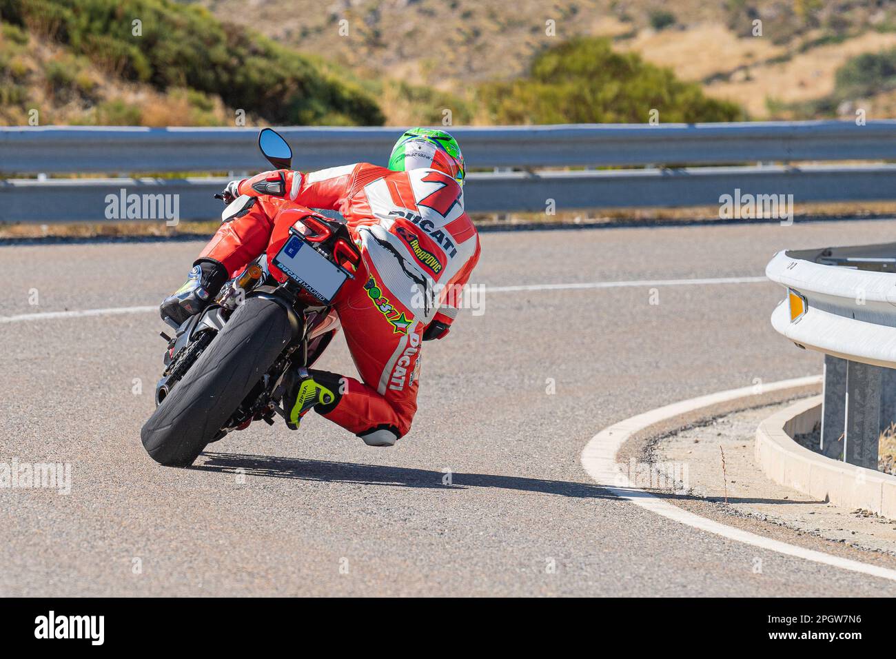 Rider on the asphalt with his bike leaning around a curve Stock Photo ...