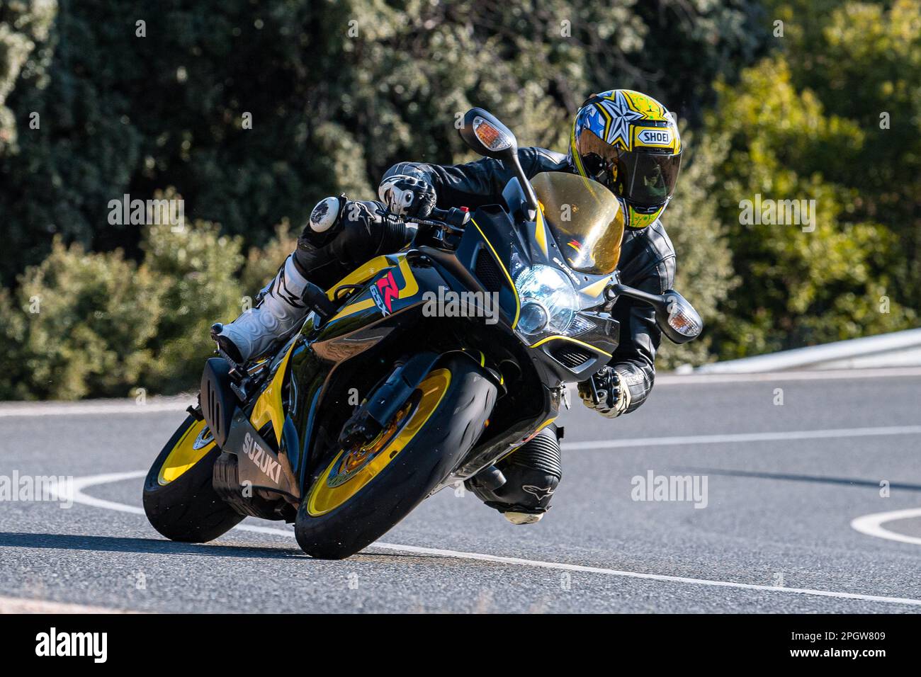 Rider on the asphalt with his bike leaning around a curve Stock Photo ...
