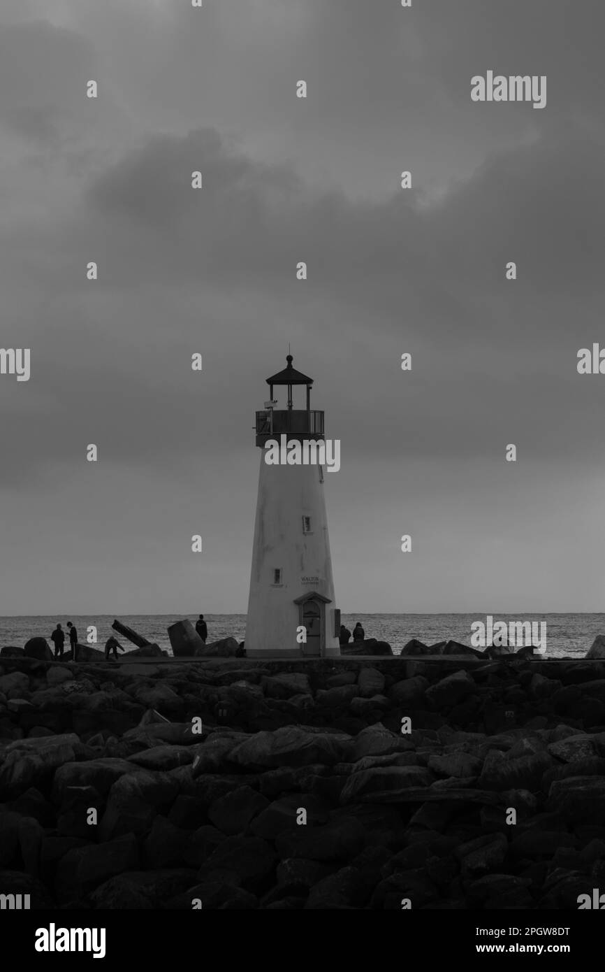 A vertical greyscale of the Walton Lighthouse on a rainy day ...