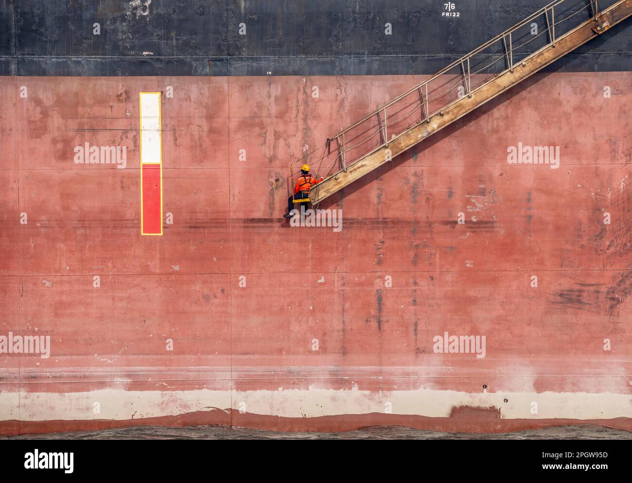 Sailor, waiting, leashed, for the pilot, on a companionway, drop ladder ...