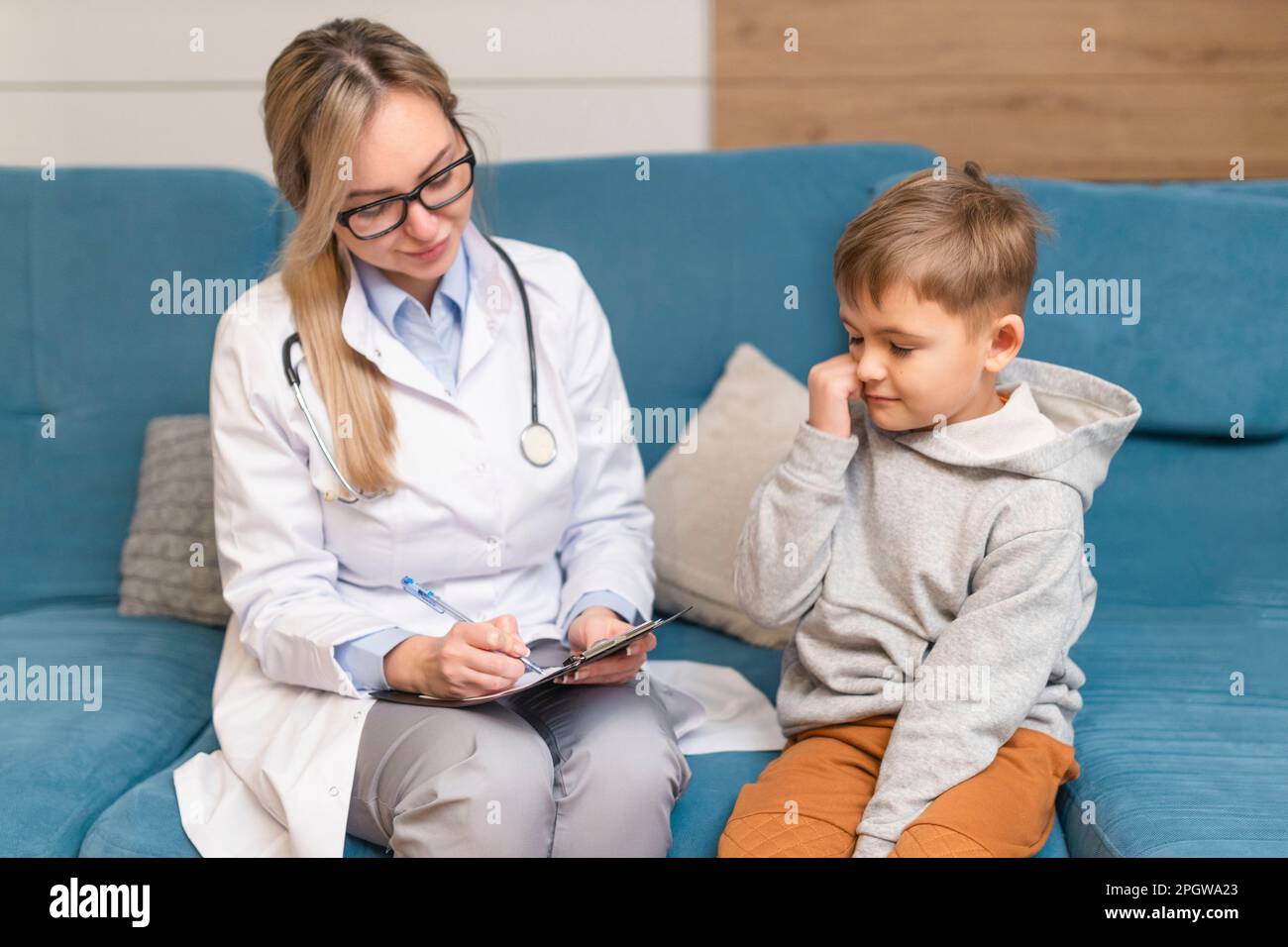 Pediatrician examines a sick child. Sick boy in the clinic. Children's ...