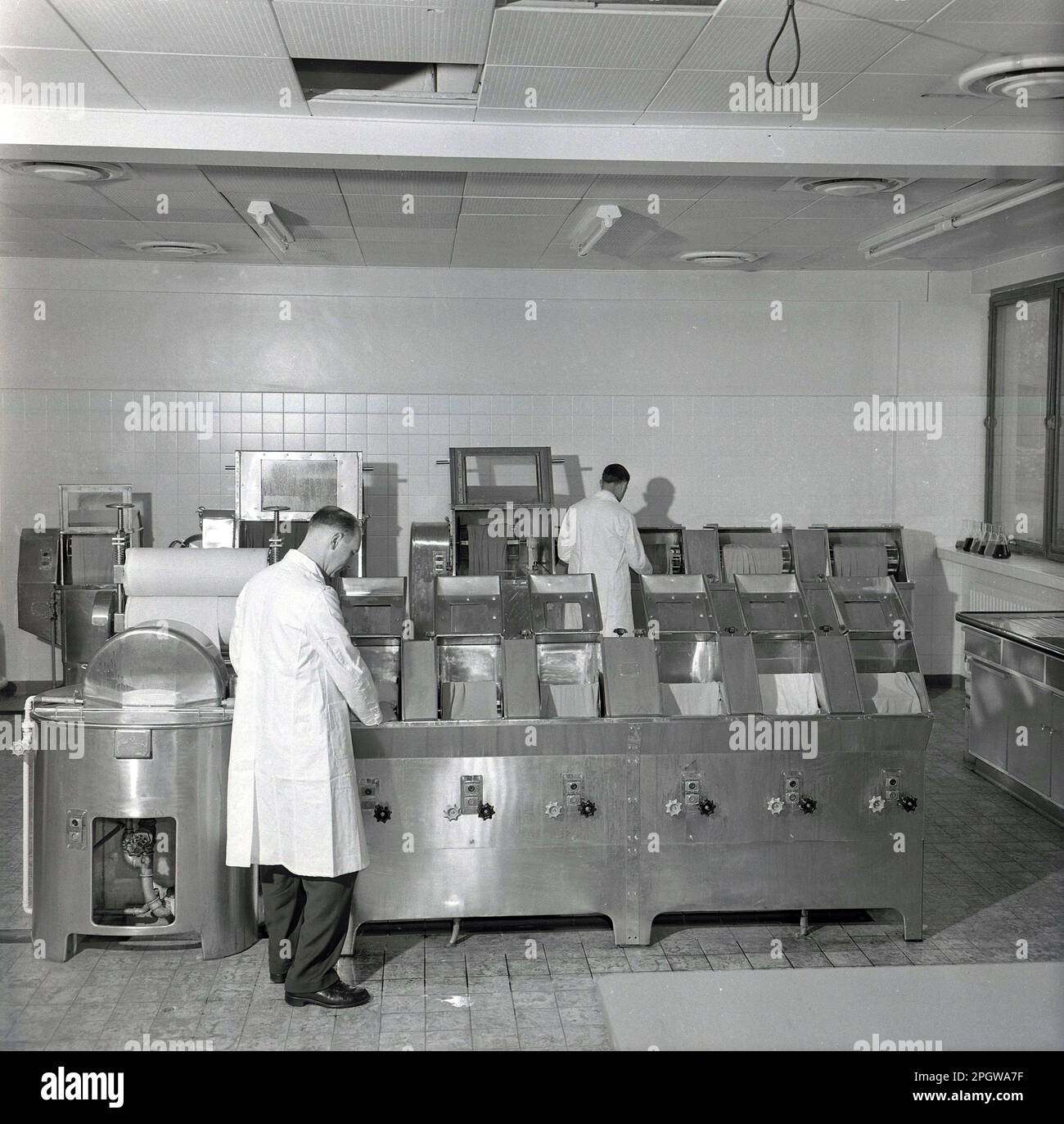 1950s, historical, industrial scientists at machines doing experiments ...