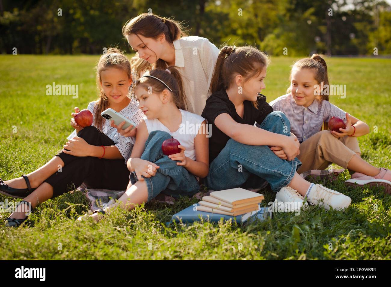 Group of school kids relaxing after classes. children spend time with ...
