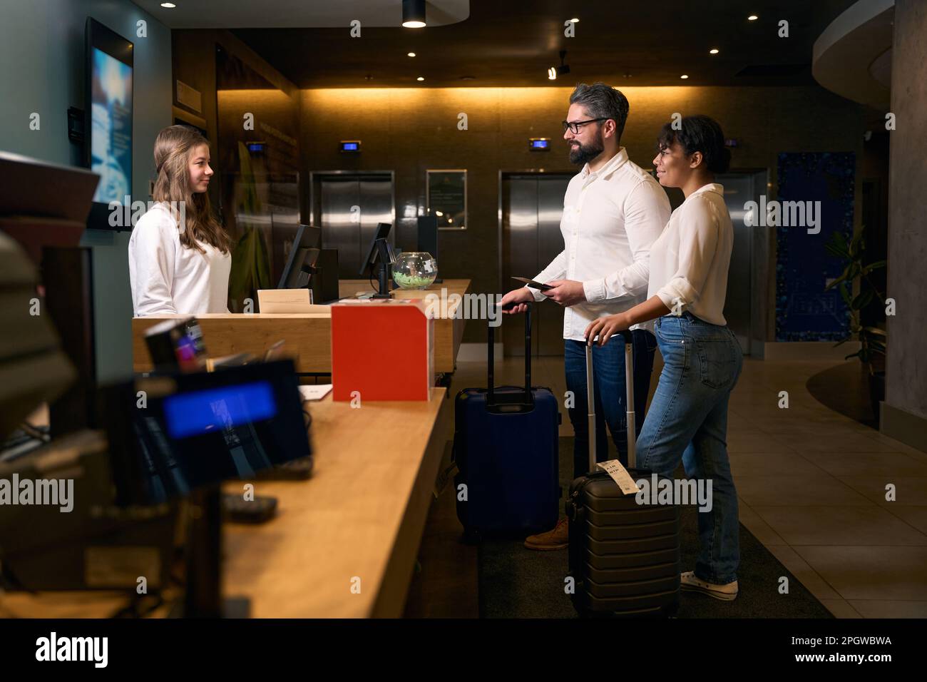 Family of three hotel reception hi-res stock photography and images - Alamy