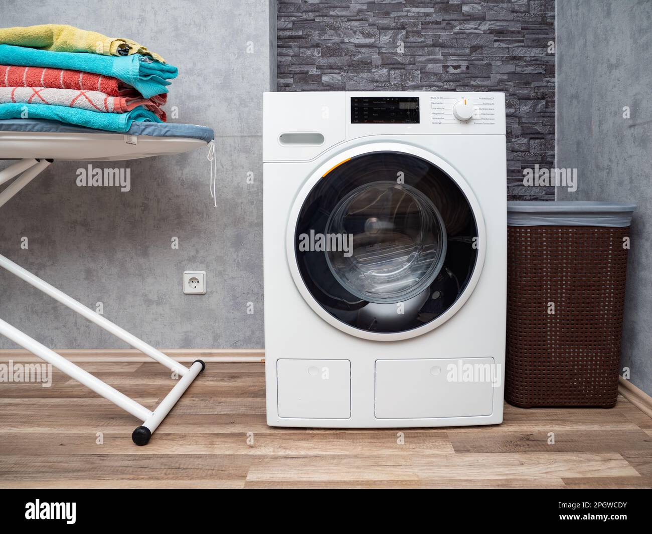 Laundry room interior with washing machine against the wall. Modern ...