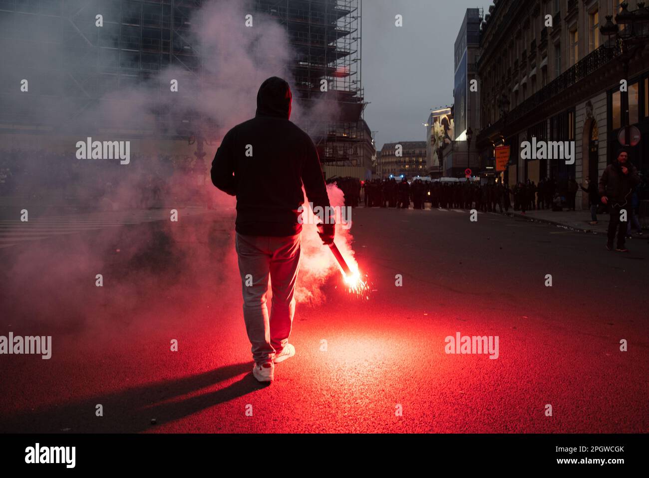 A man holding a smoke flare confronts the French Gendarmerie during a ...