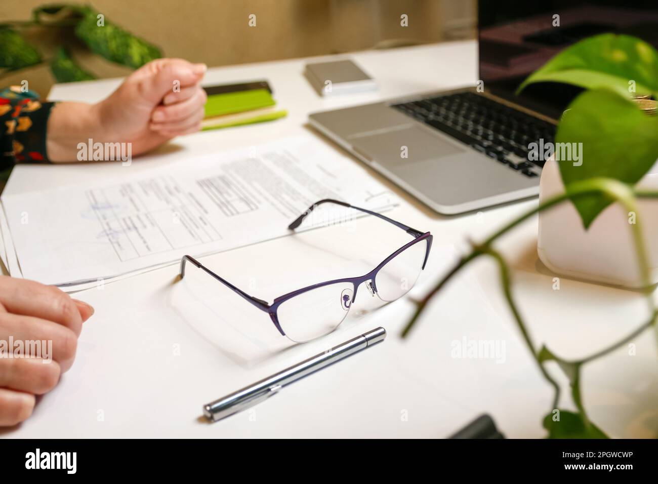 Eyeglasses for office work. Office workplace. White wooden table with ...