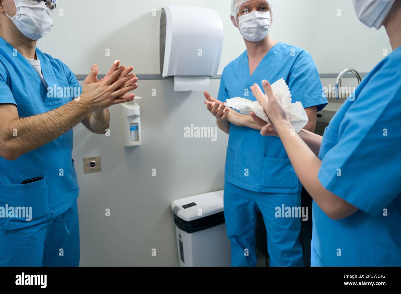 Group of medical workers treats their hands with a sanitizer Stock ...