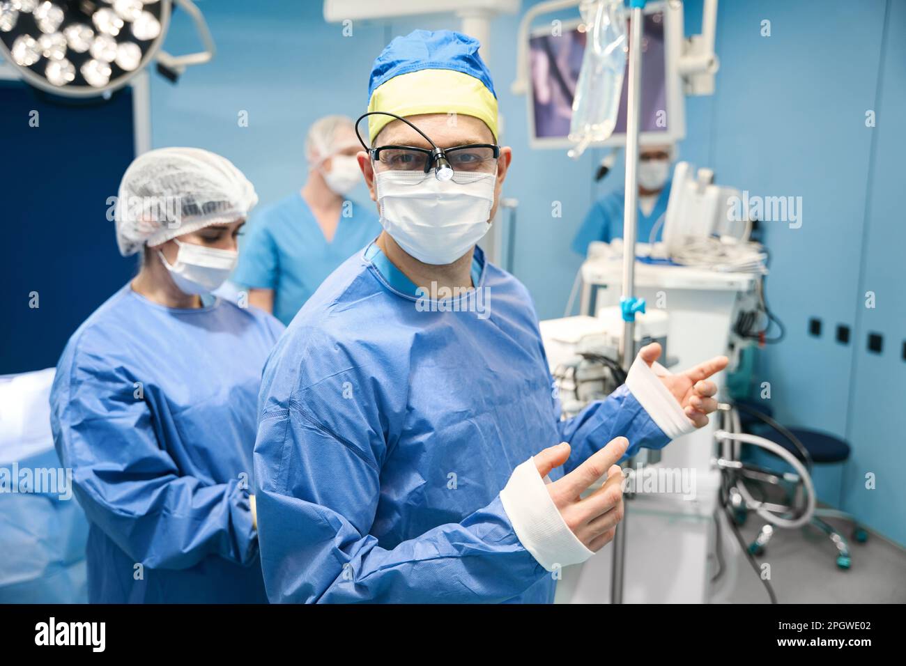 Surgeon is dressed in a sterile gown before the operation Stock Photo ...