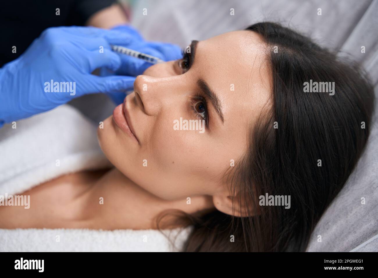 Doctor doing face anti-aging injections to lady in salon Stock Photo ...