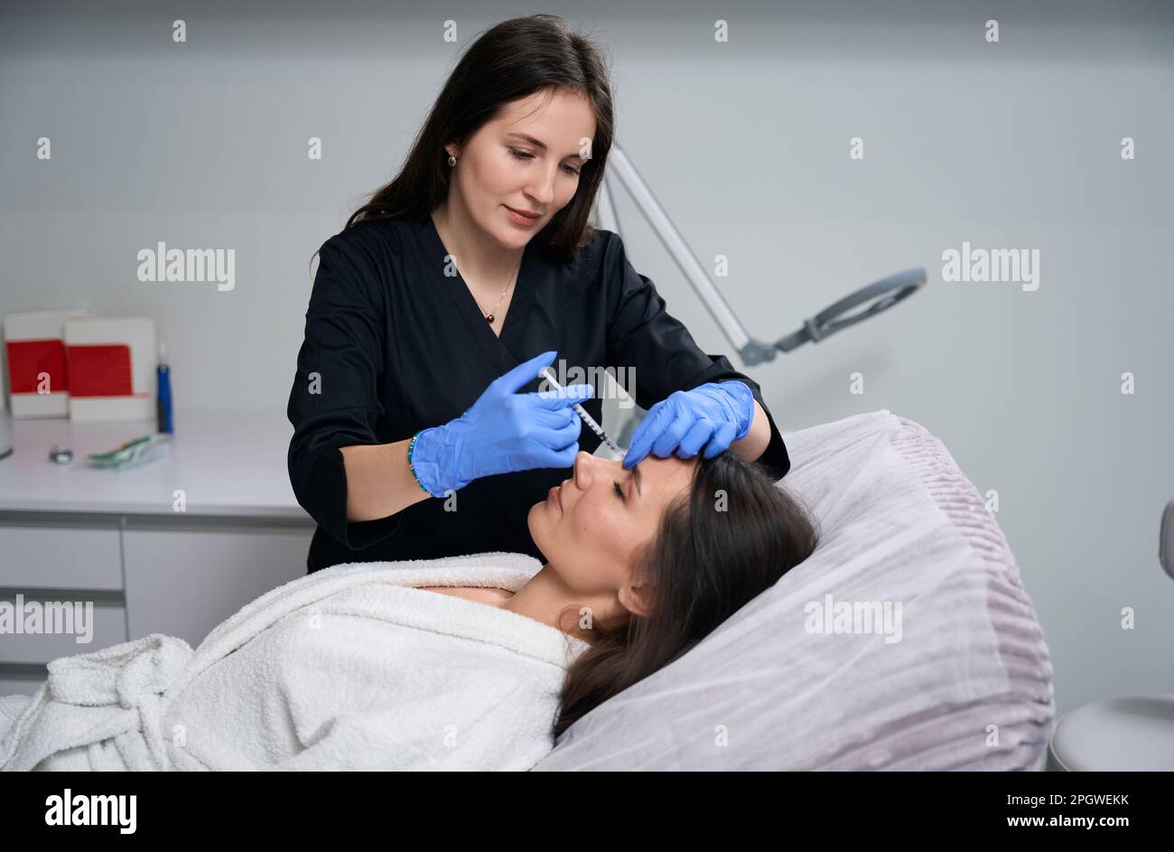 Doctor doing anti-aging injections to beautiful client in salon Stock ...