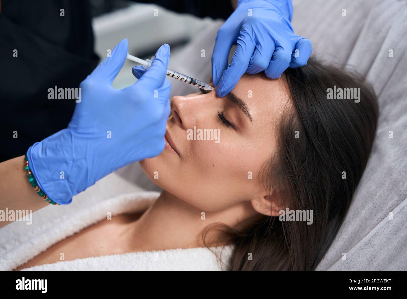 Doctor doing face anti-aging injections to female in salon Stock Photo ...