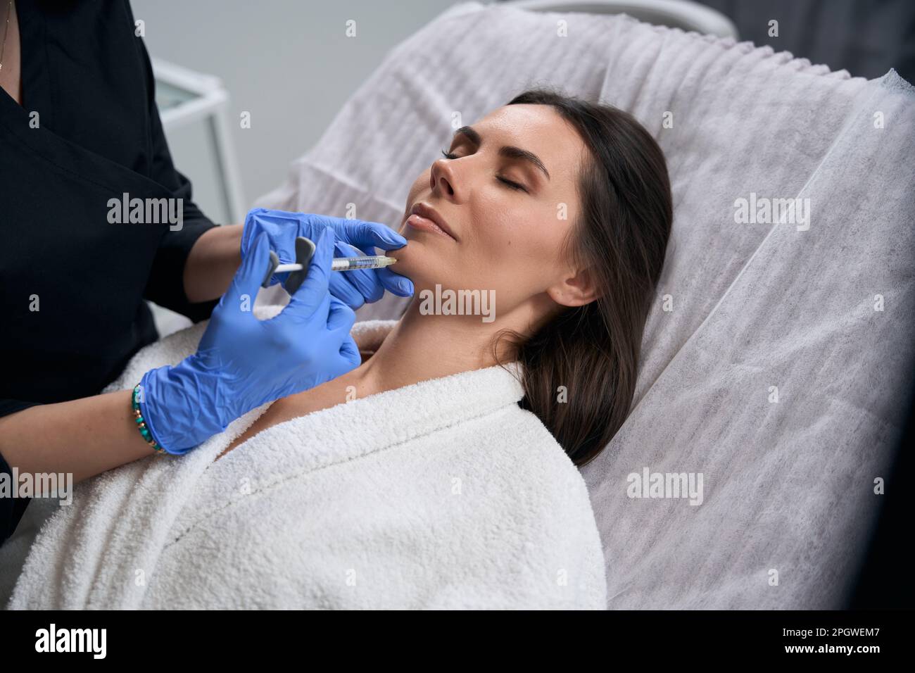 Nurse doing anti-aging injections to beautiful client in salon Stock ...