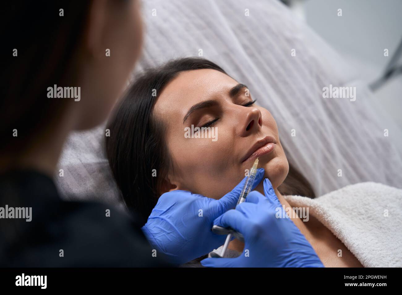 Female doing anti-aging injections to beautiful client in salon Stock ...