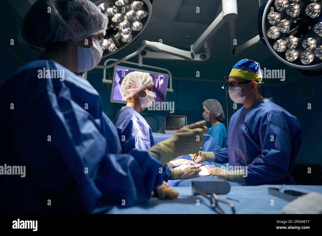 Team of doctors operates on patient in modern operating room Stock ...