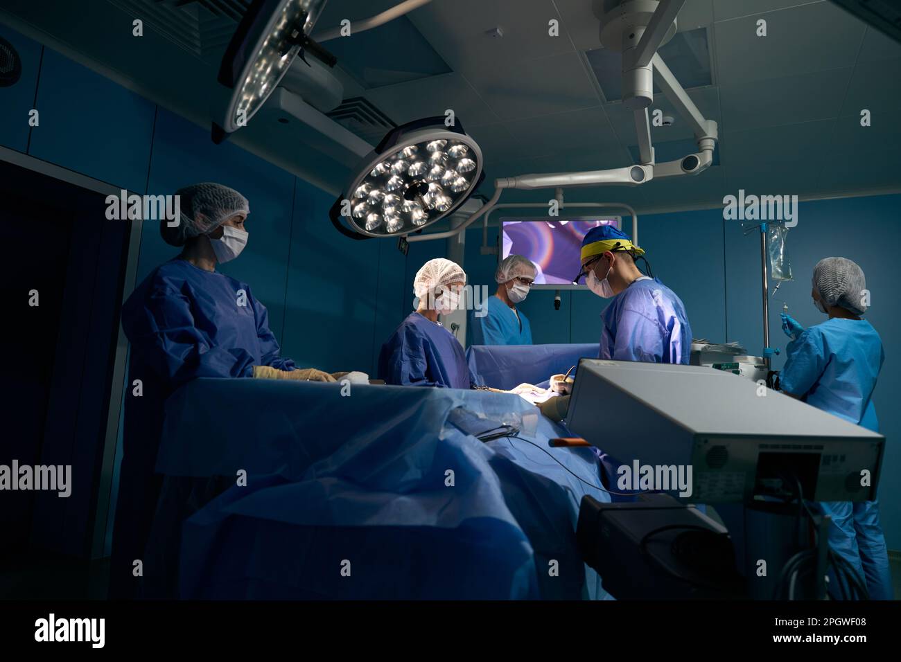 Teamwork of a surgeon, anesthetist and assistants in operating room ...