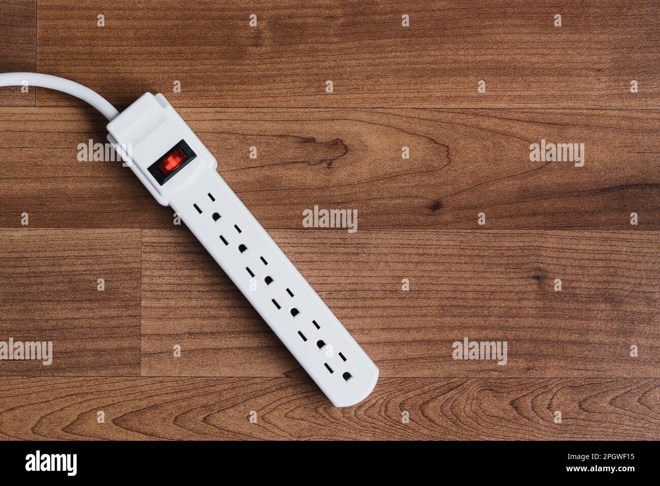 Electrical power strip or bar on wood floor Stock Photo - Alamy