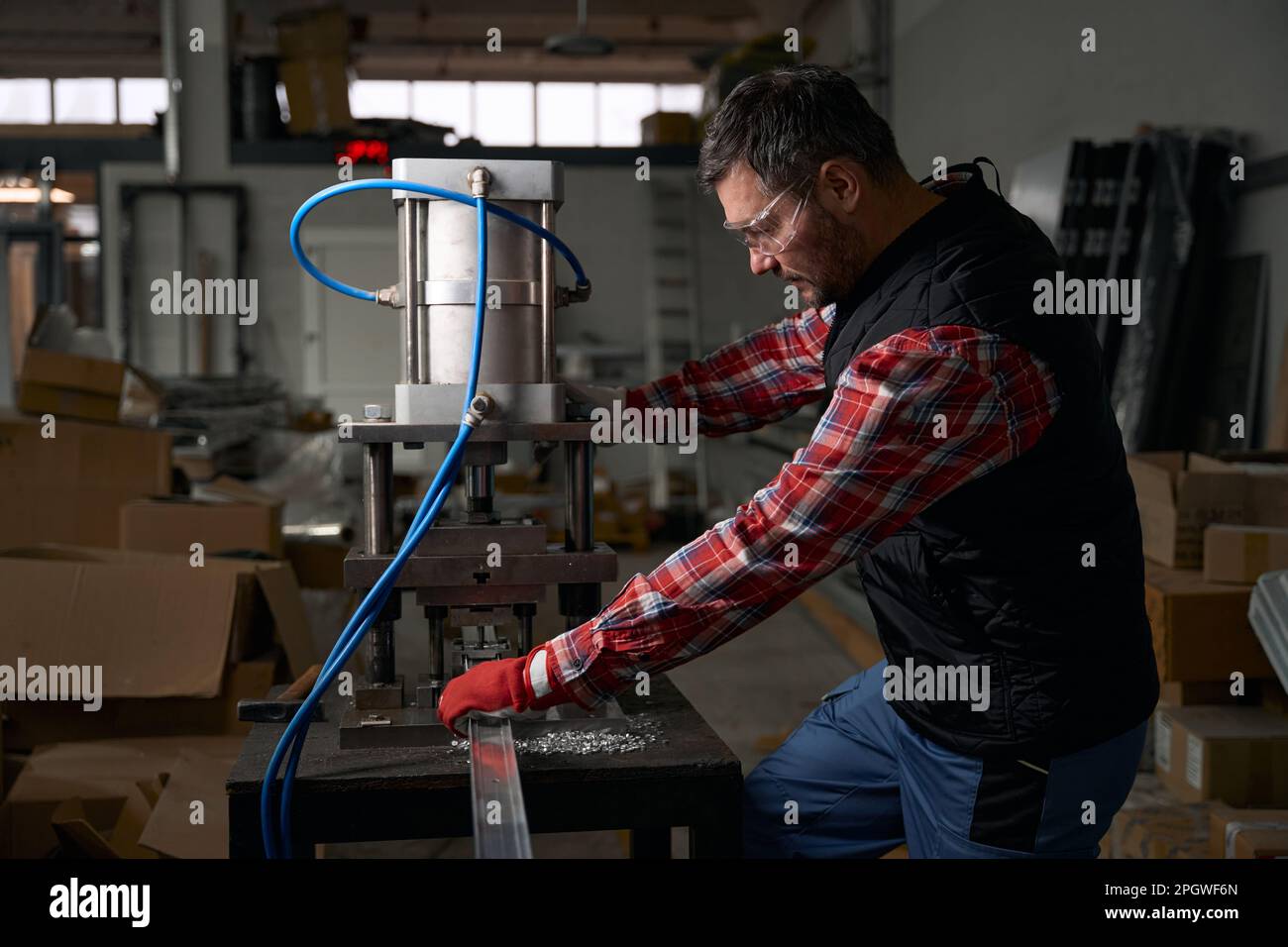 Adult man operating equipment in the factory Stock Photo - Alamy