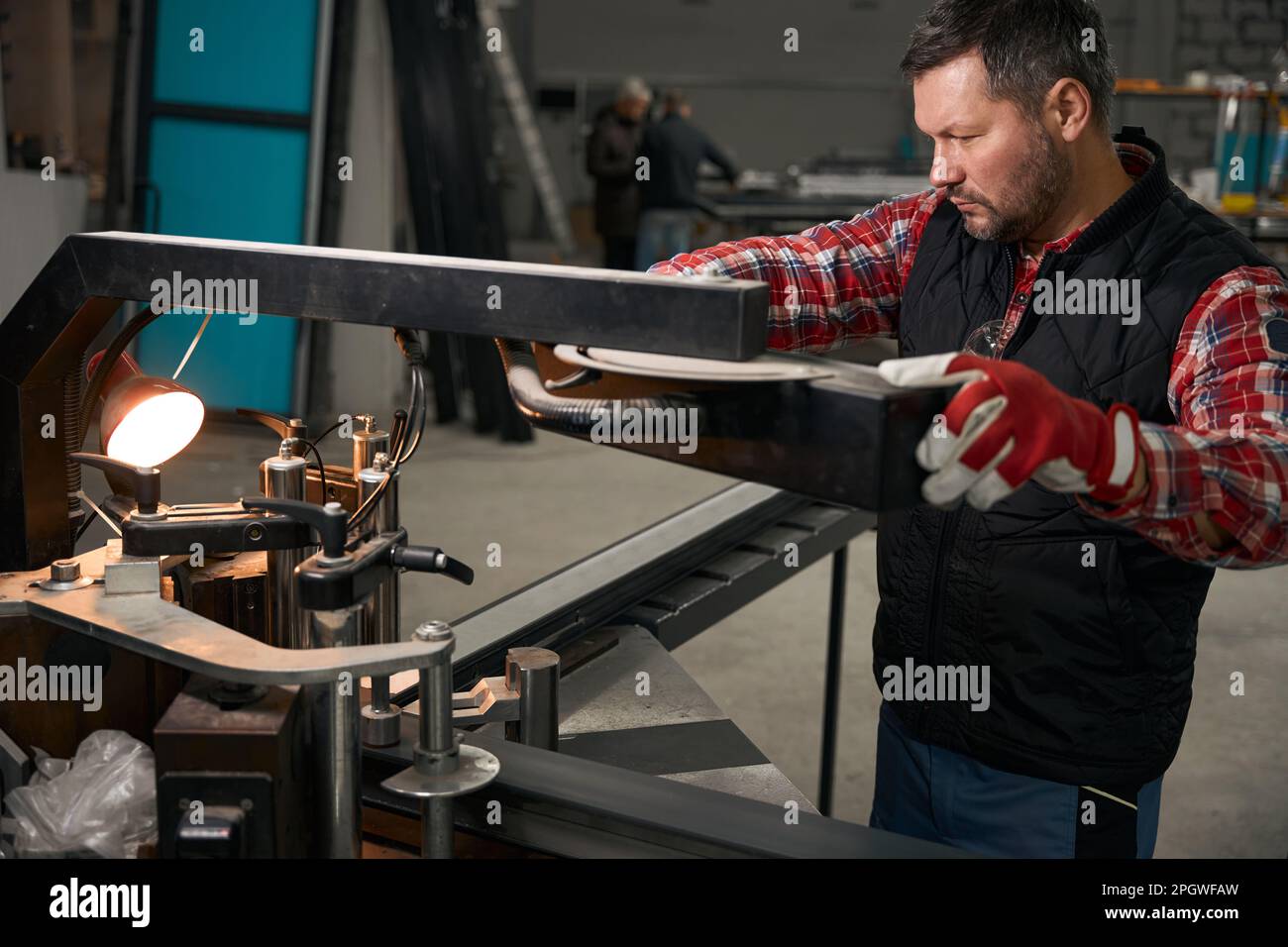 Adult male preparing machine for working in the workshop Stock Photo ...
