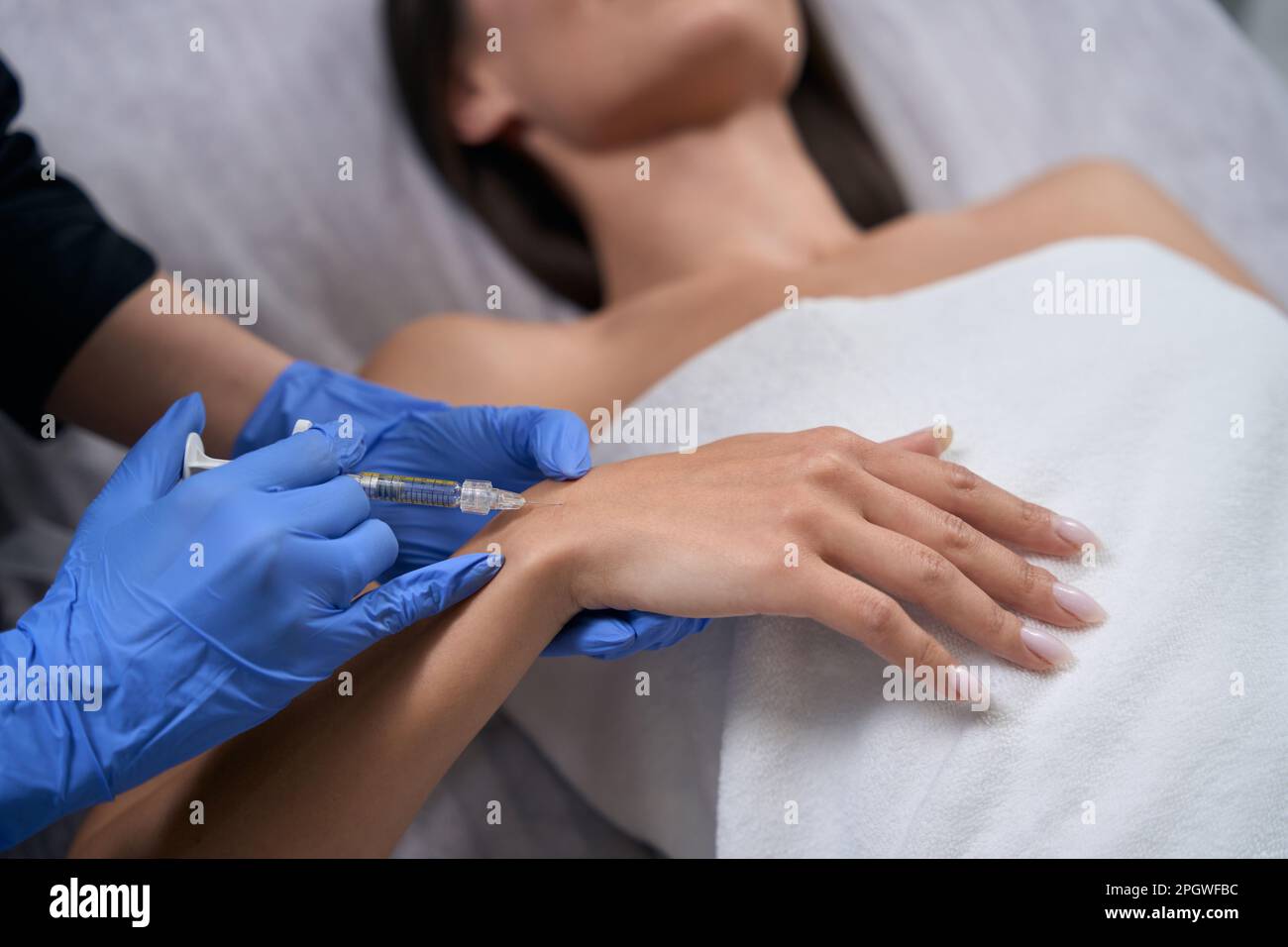 Medic doing injections in salon to pretty woman Stock Photo - Alamy