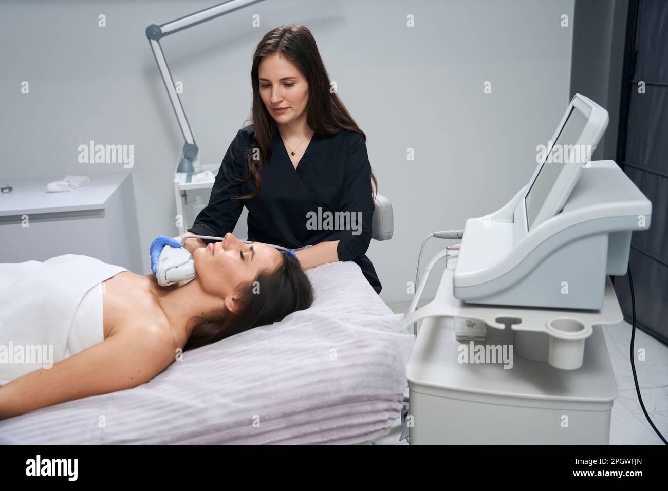 Beautician doing facial skin rejuvenation procedure for young female ...