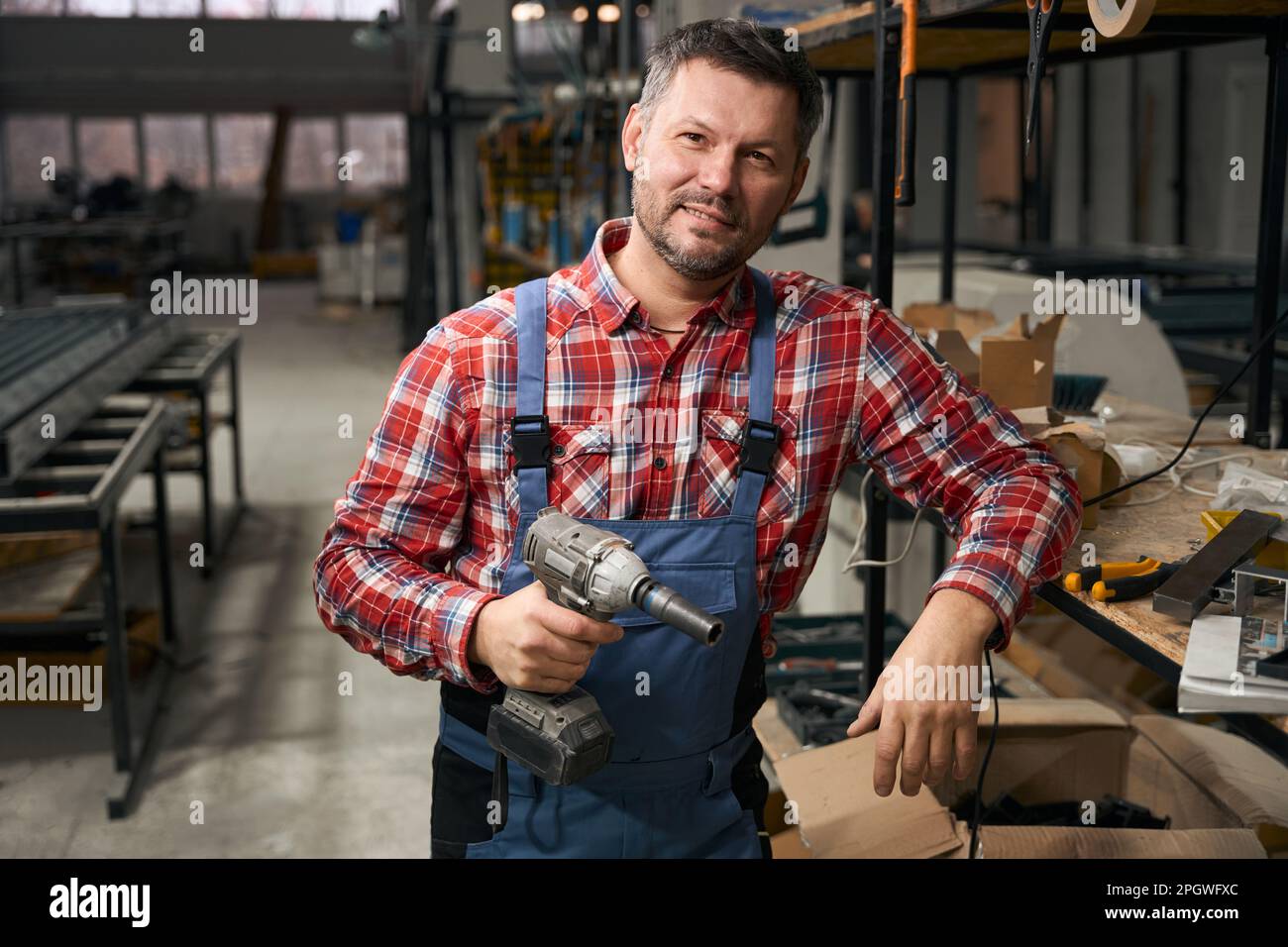 Portrait of adult employee ready to work in factory Stock Photo - Alamy