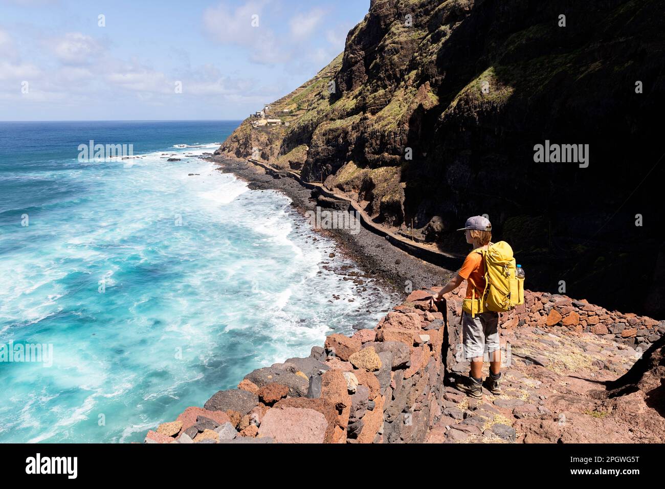 Mother and son, hikers on coastal hiking trail to Ponta do Sol ...