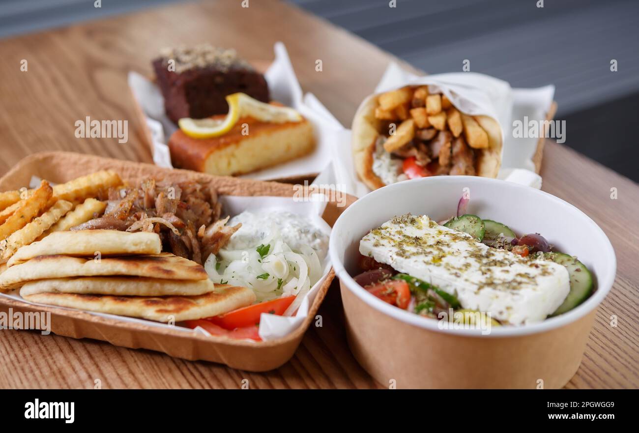 Traditional Greek fast food meal served in recyclable paper dishware ...