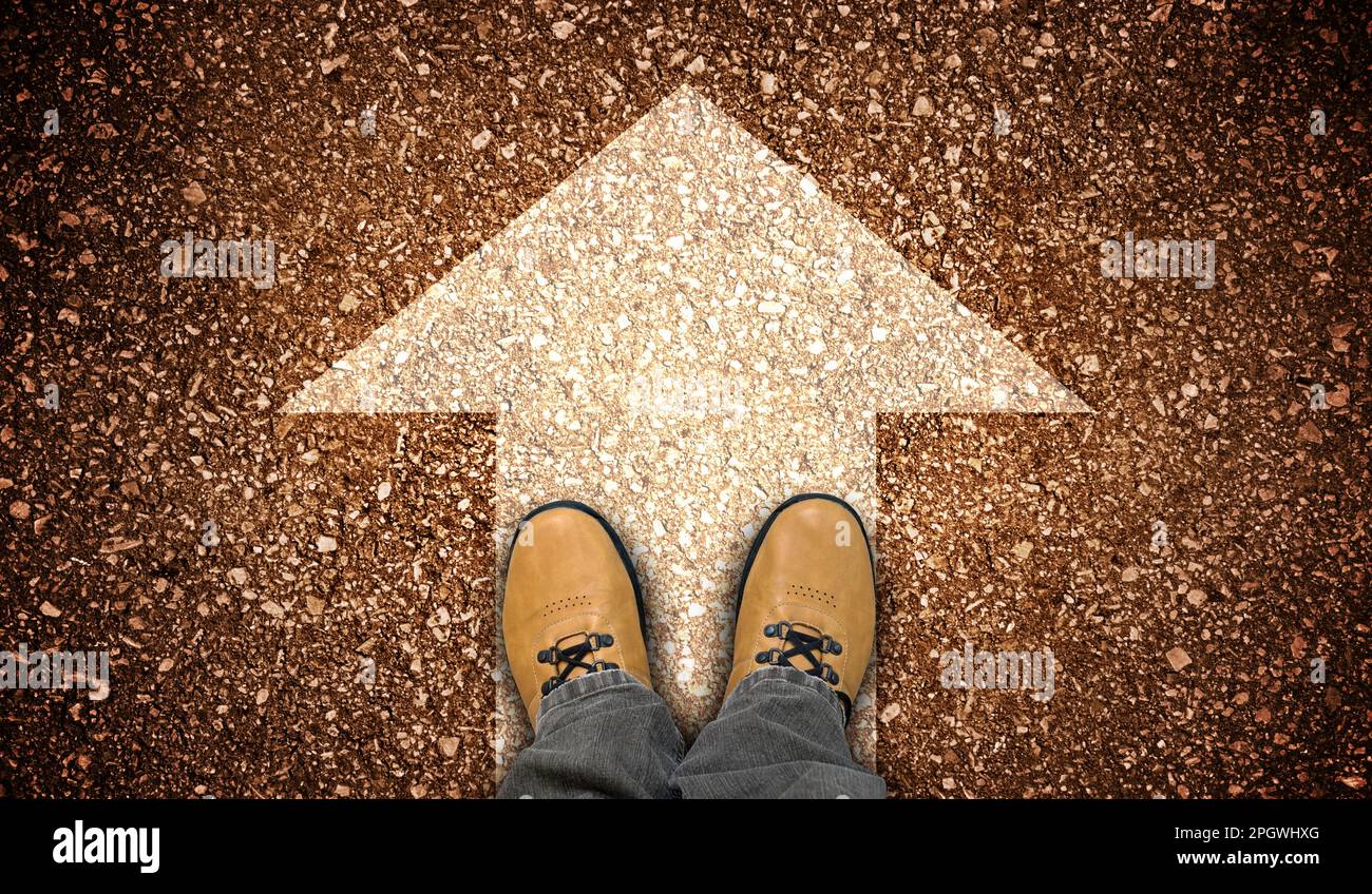 Yellow leather shoes and chalky arrow on ground - forward concept Stock ...