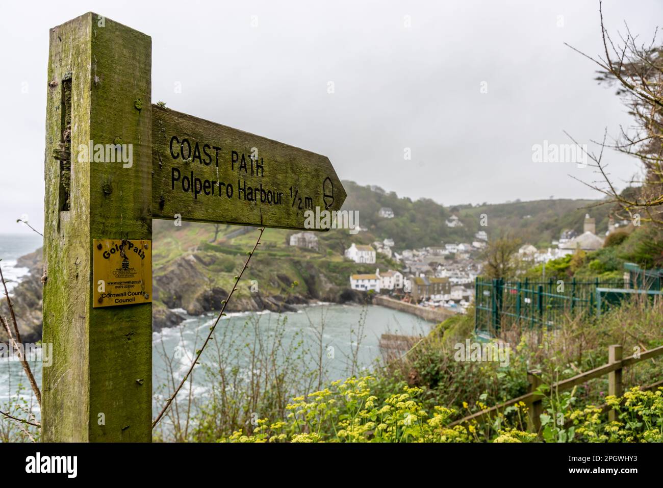 Wooden arrow pole showing direction and distance to Polpero Cornwall,UK ...