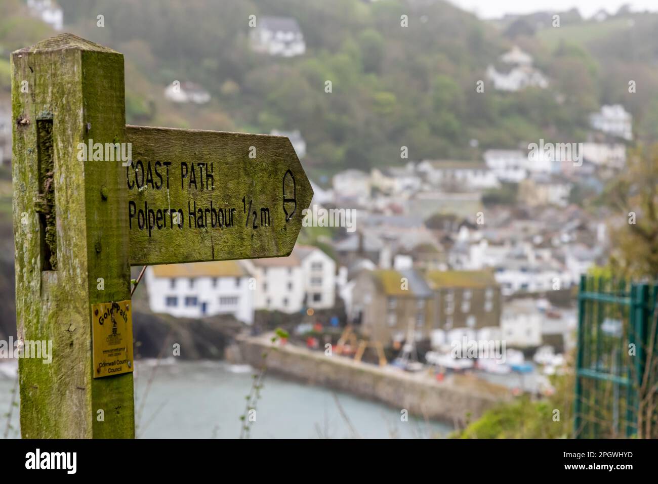 Wooden arrow pole showing direction and distance to Polpero Cornwall,UK ...