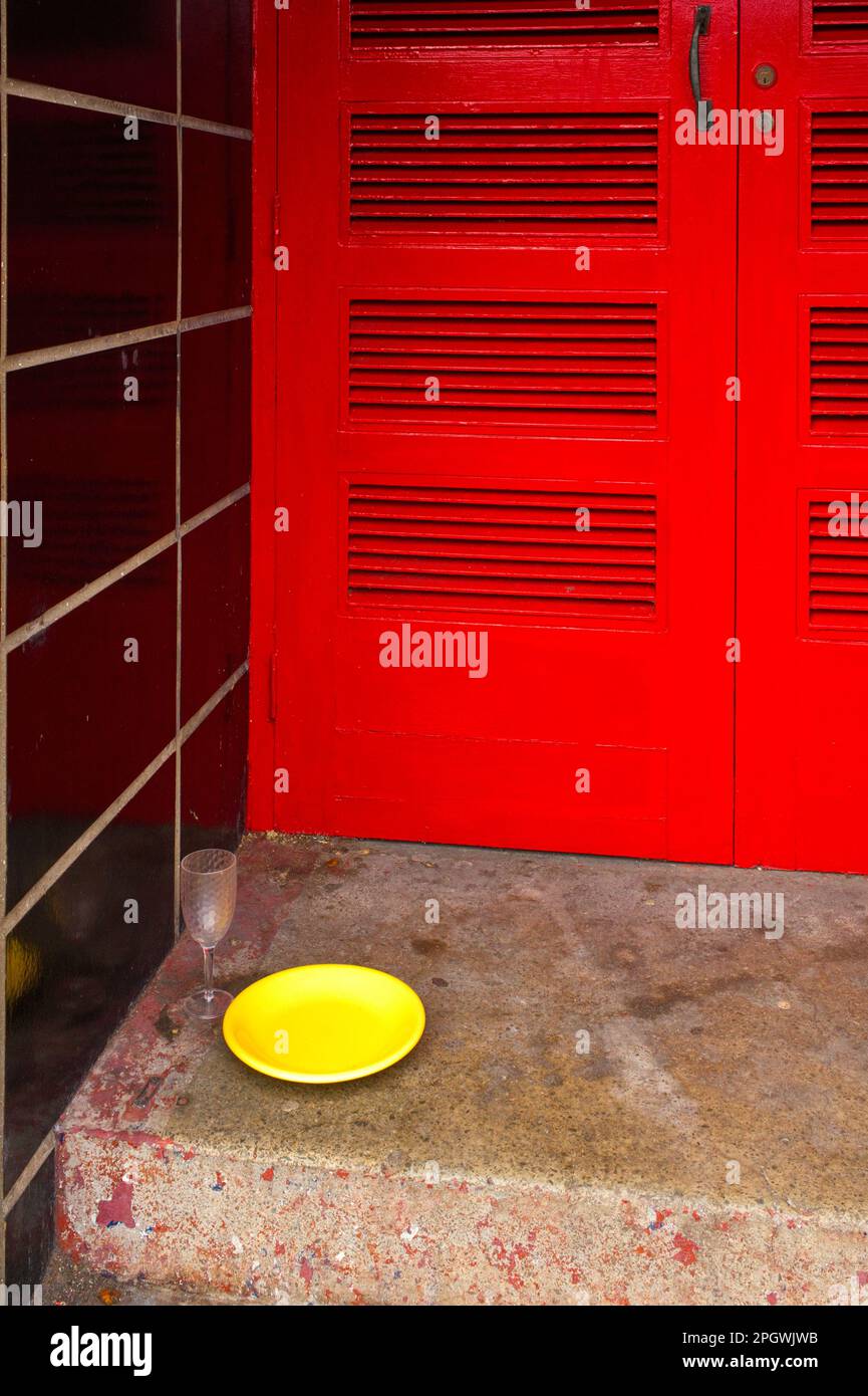 A plastic plate and glass left outside the stage door of a theatre ...
