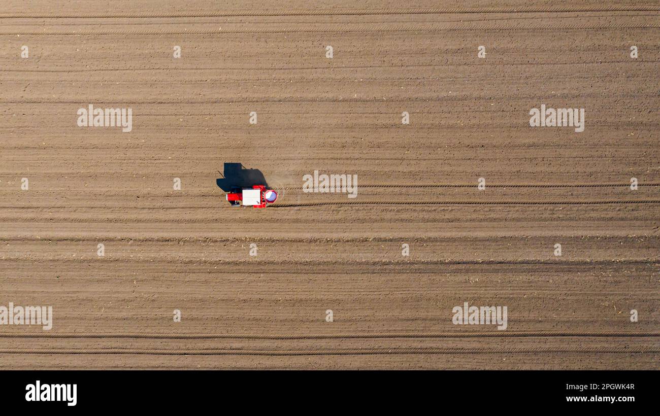 Above top view on tractor as throws, fertilizing arable farmland for ...