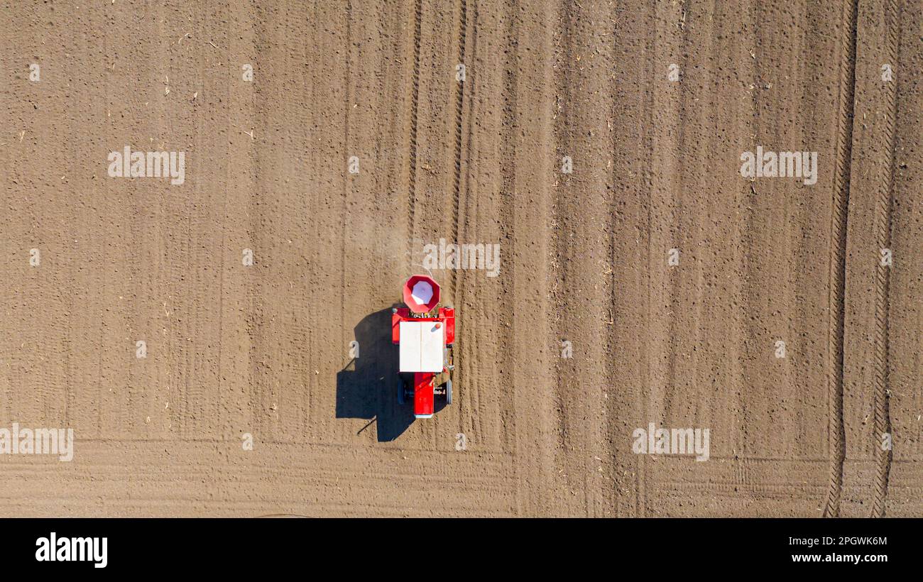 Above top view on tractor as throws, fertilizing arable farmland for ...
