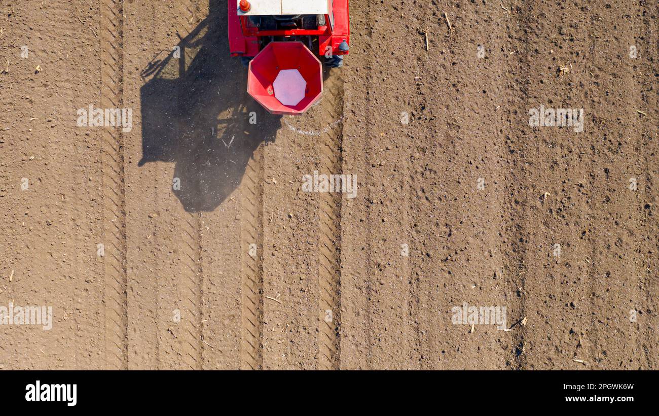 Above top view on tractor as throws, fertilizing arable farmland for ...