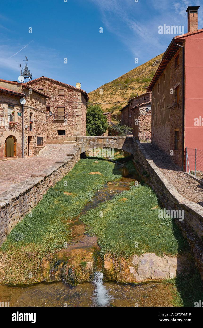 Stream flowing through the middle of an old town in Spain Stock Photo ...