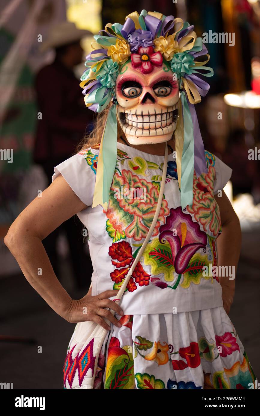 A young female wearing a skeleton-inspired costume and a flower ...
