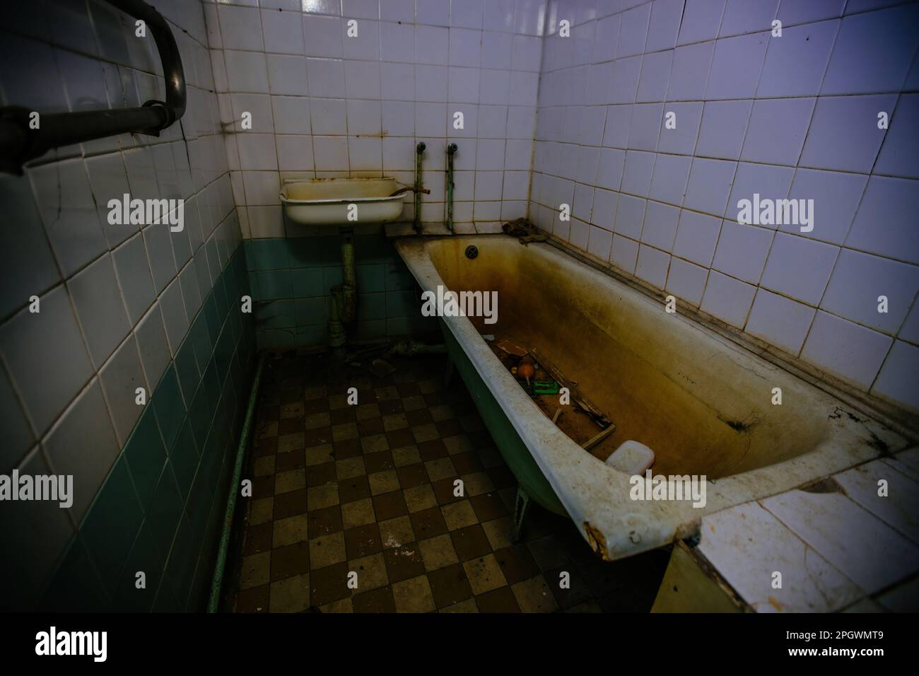 Creepy bath room in abandoned hospital. Red illuminated, horror concept ...