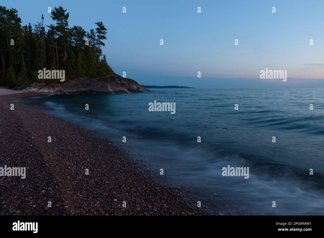 The beach and rocks at Agawa Bay at dusk, Lake Superior Provincial Park ...