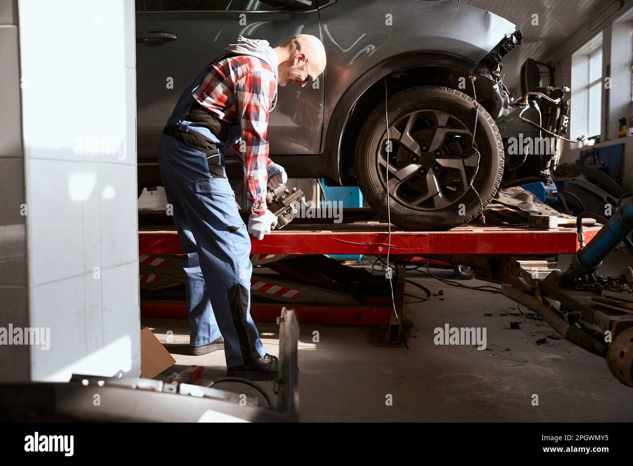 Car after an accident during repairs in a car shop Stock Photo - Alamy