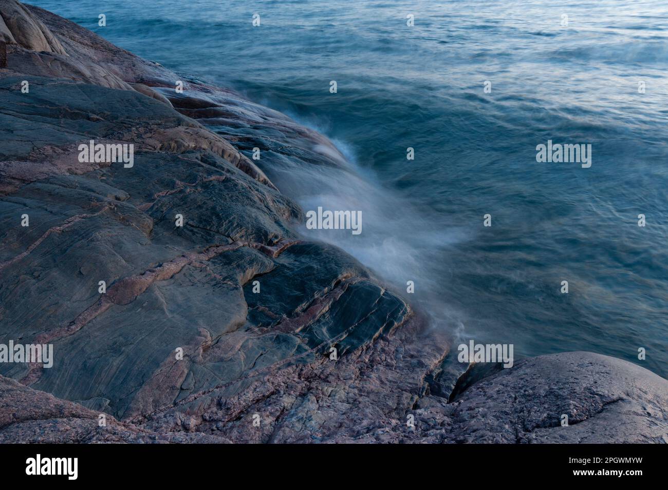 Dusk over the granite rocks of the Canadian Shield rocks and the waters ...
