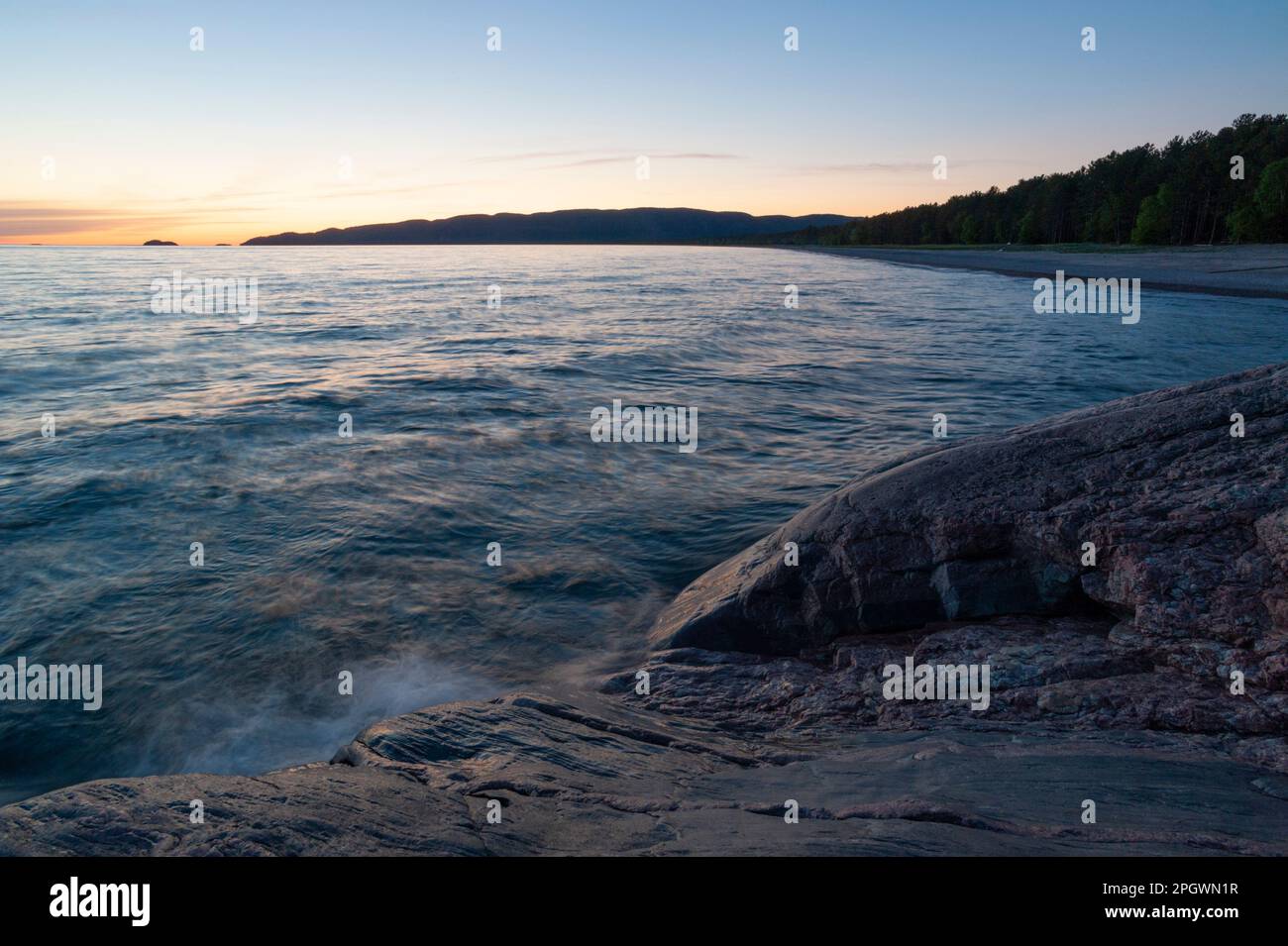 The beach and rocks at Agawa Bay at dusk, Lake Superior Provincial Park ...