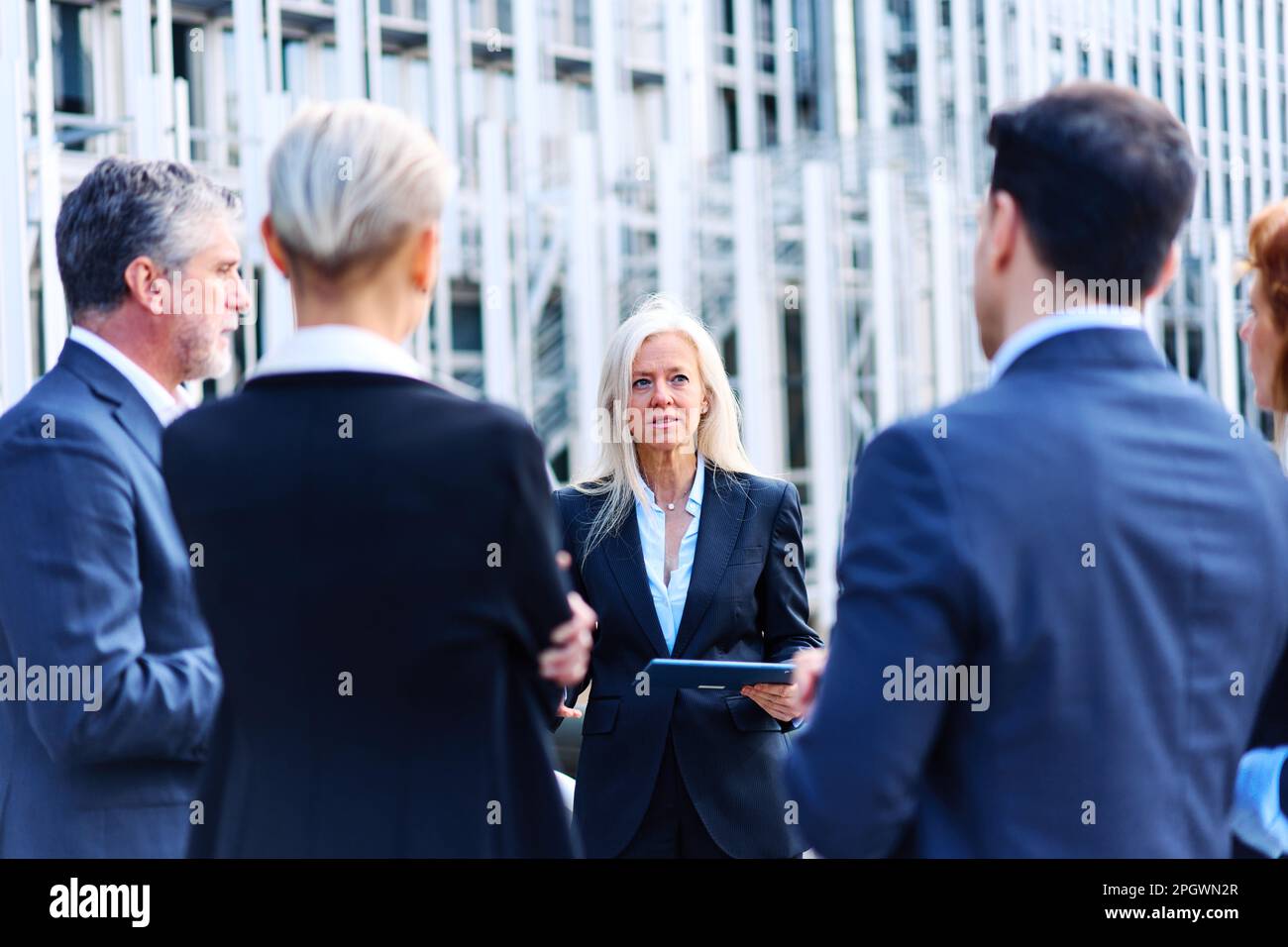 Group of business people talking outside a financial building Stock ...