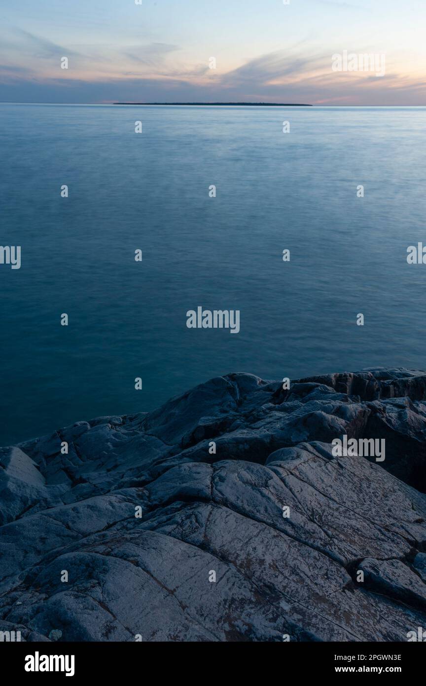 Dusk over the granite rocks of the Canadian Shield rocks and the waters ...