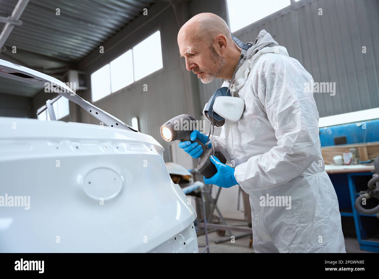 Painter uses a special flashlight to select paint for car Stock Photo ...