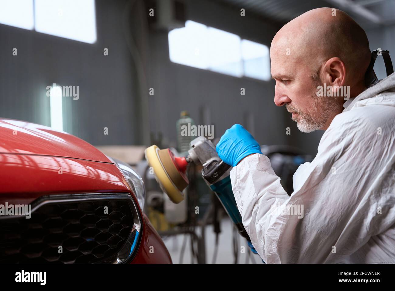 Man stage of polishing the stripped sections of red car Stock Photo - Alamy