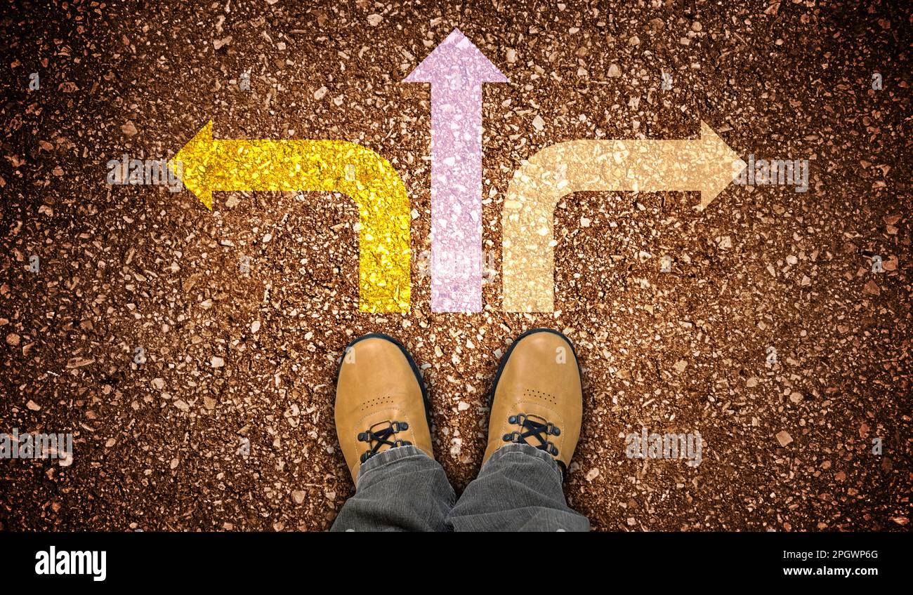 Yellow leather shoes and three colorful chalky arrows on ground ...